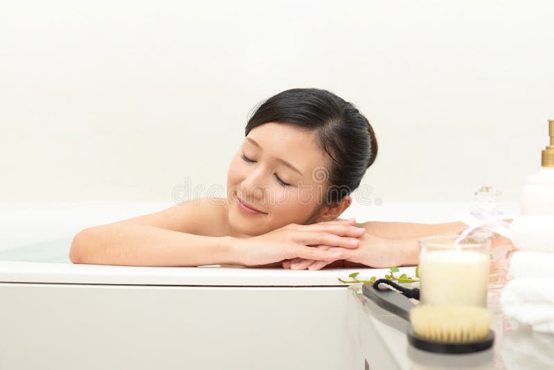 Woman taking relaxing bath stock image. Image of bathing - 134361199