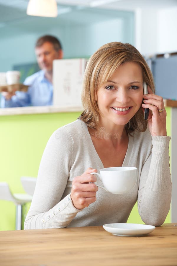 Woman Talking on Mobile Phone in Coffee Shop Stock Photo - Image of ...