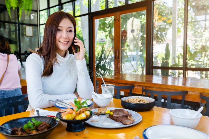Woman Talking on Mobile Phone in Restaurant Stock Image - Image of ...