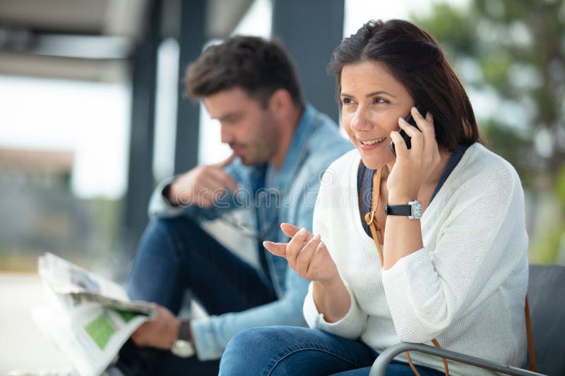 Woman Talking on Phone while Waiting for Bus at Busstop Stock Image ...