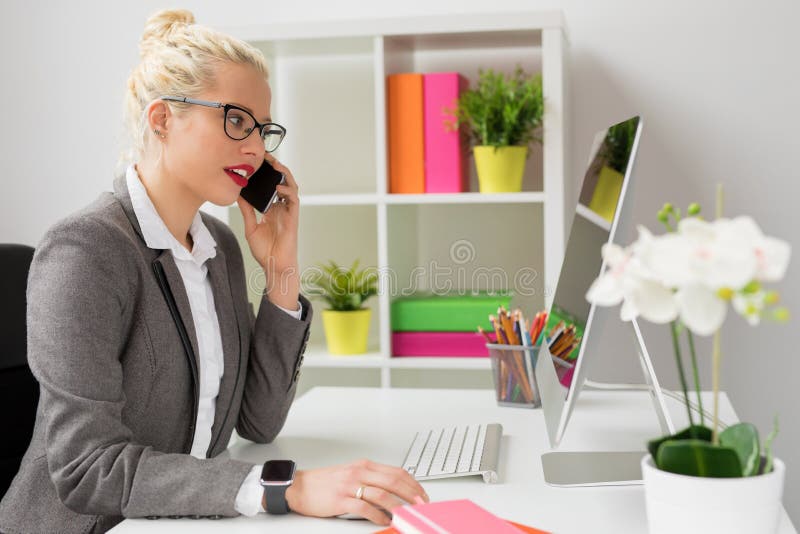Woman Talking on the Phone and Working on Computer Stock Image - Image ...