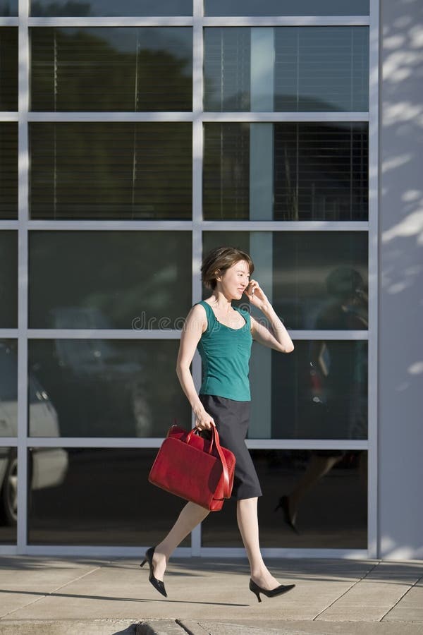 Woman Talks on Phone while Running - Vertical Stock Photo - Image of ...