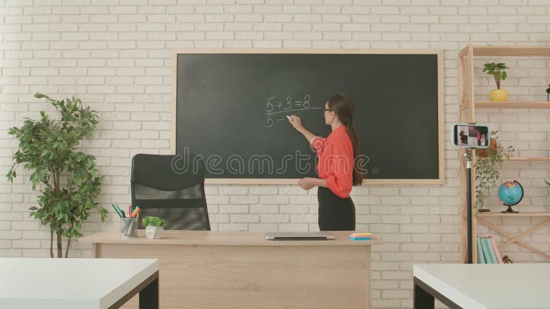 Woman Teacher in Classroom Streaming Live Video Lesson Conference ...