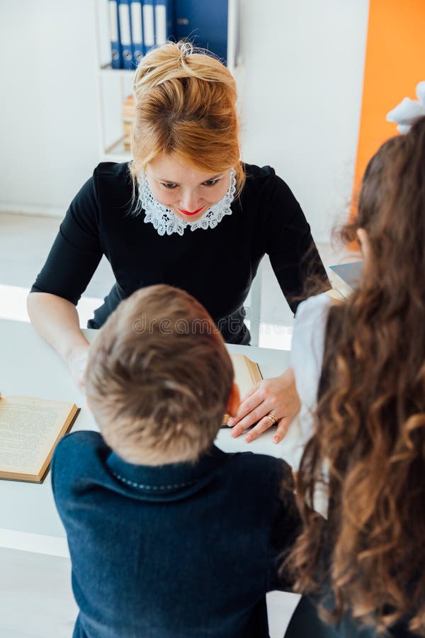Woman Teacher Librarian in a Lesson at School with Children Stock Image ...