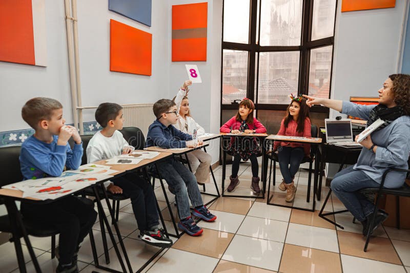 Woman Teaching a Group of Elementary Students at Language School Stock ...