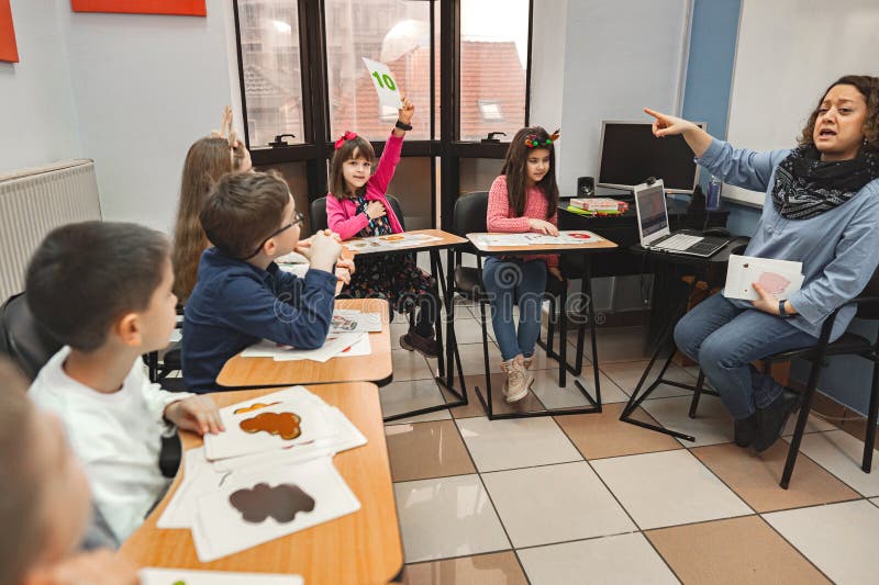 Woman Teaching a Group of Elementary Students at Language School Stock ...