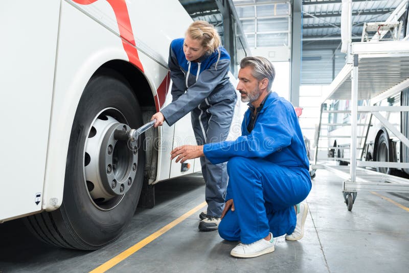 Woman Technician Working with Wheel in Bus Stock Image - Image of ...