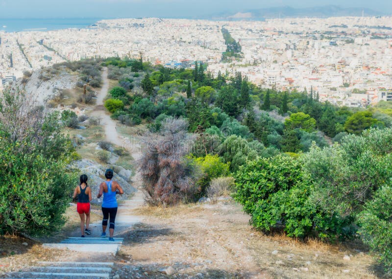 Woman and Teen Running in Athens Down Path Stock Photo - Image of ...