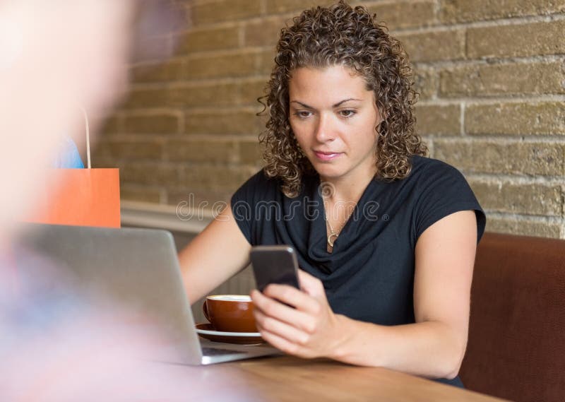 Woman Texting in Cafe stock image. Image of drinking - 37127219