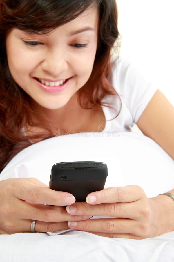 Woman Texting on Phone Lying on Bed Stock Image - Image of ...