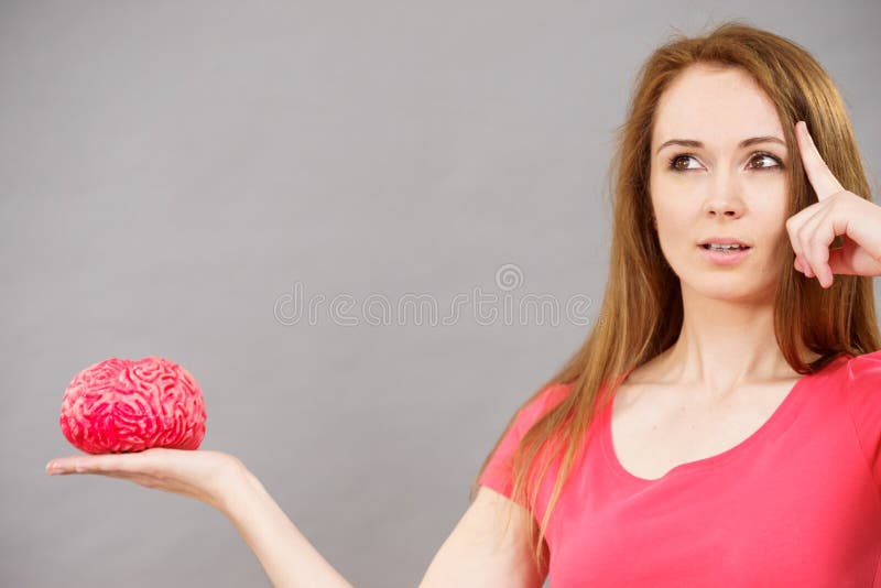 Woman thinking holds brain stock photo. Image of education - 232731522