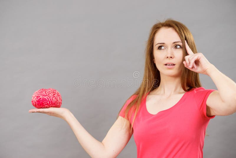 Woman thinking holds brain stock photo. Image of think - 251271834