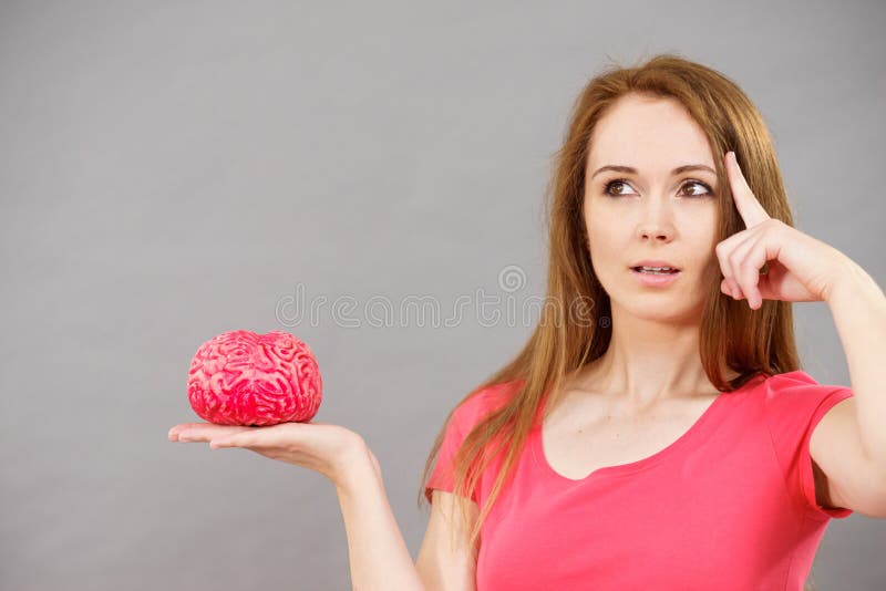 Woman thinking holds brain stock photo. Image of wondering - 356537150