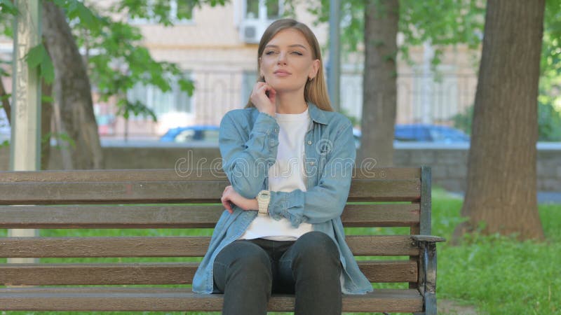 Woman Thinking while Sitting on Bench in Park Stock Footage - Video of ...