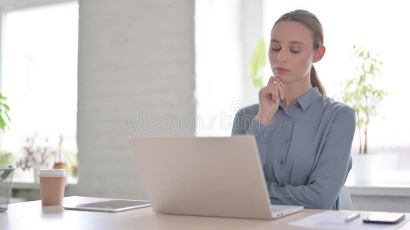 Woman Thinking while Working on Laptop in Office Stock Image - Image of ...