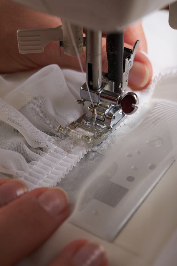 Woman Threading on Sewing Machine Stock Photo - Image of overstitching ...