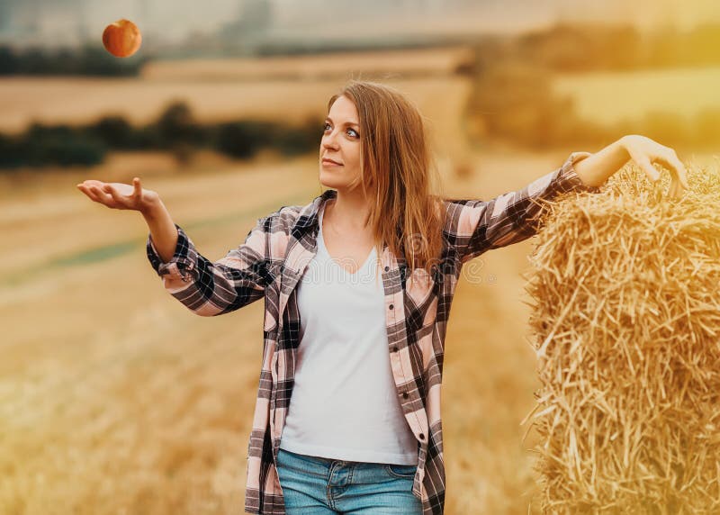 Woman Throwing an Apple Up in a Wheat Field Stock Photo - Image of ...