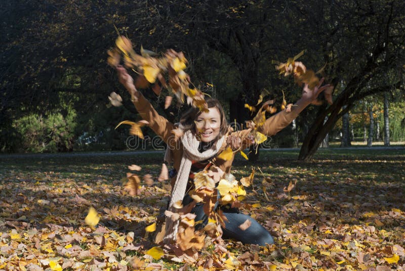 Woman Throwing Leaves in Fall Stock Photo - Image of leaves, drop: 27281588