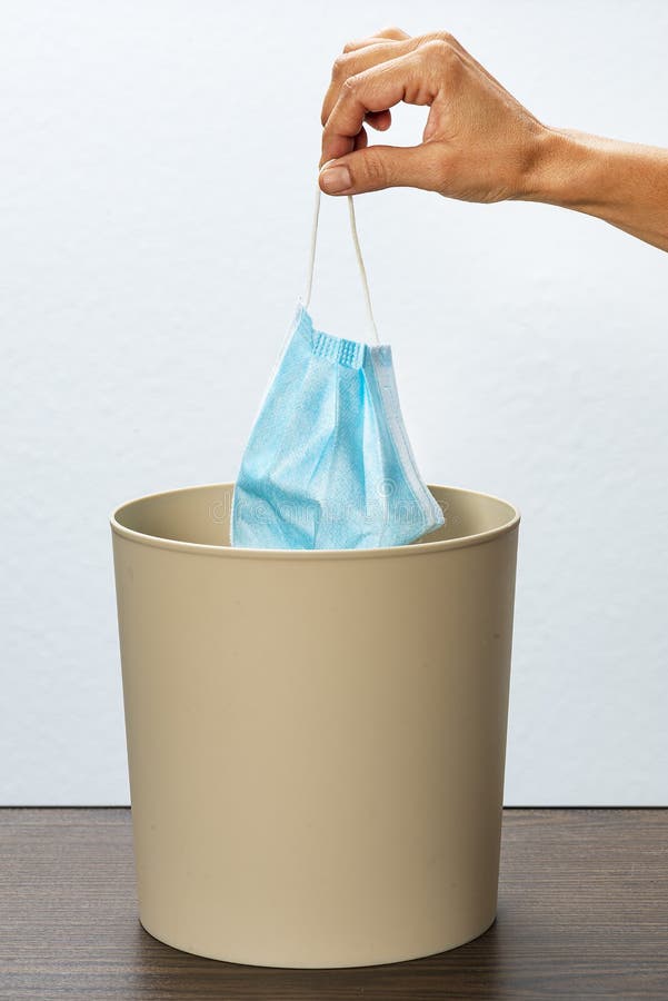 Woman Throwing a Mask into the Garbage Can Stock Image - Image of ...