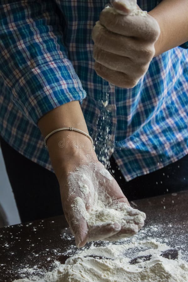 A Man Throwing Flour From His Hands On A Wooden Table. Indoors. Stock ...