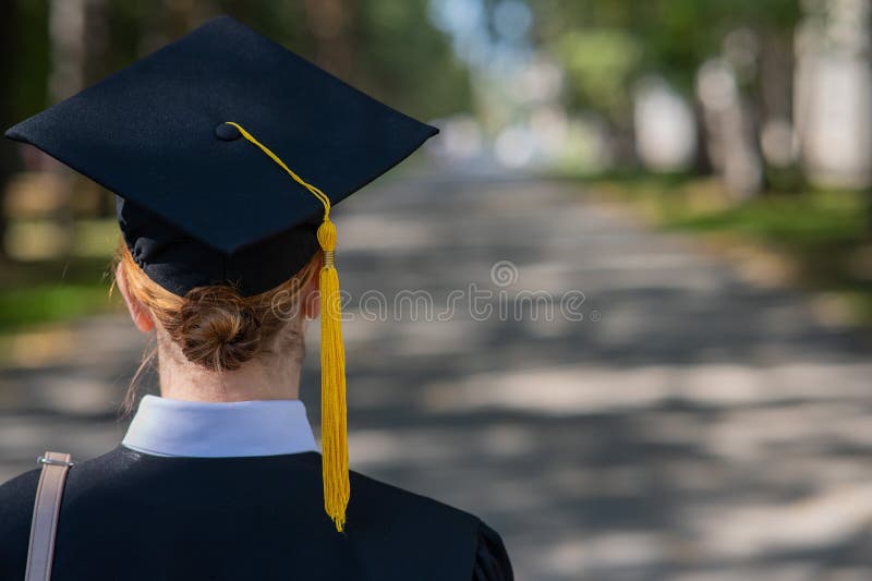 A Woman Throws Her Graduation Cap Against the Blue Sky. Stock Photo ...