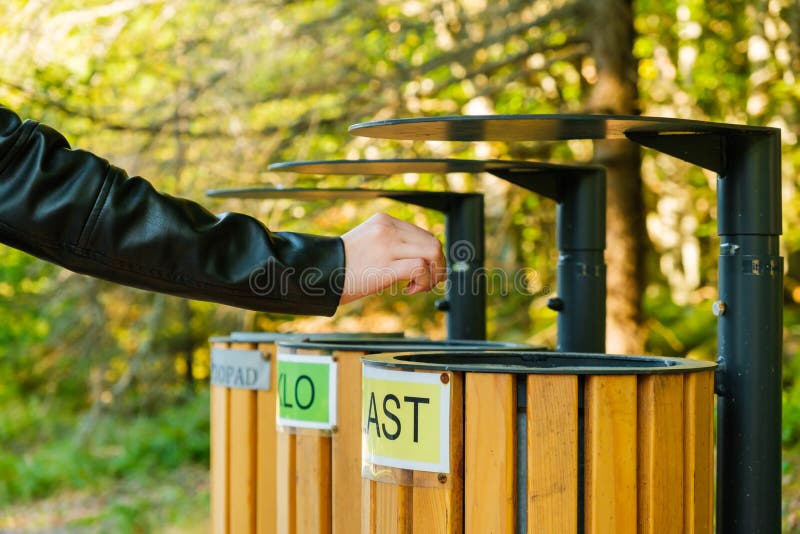 Woman Throws Out the Trash. Waste Sorting in the Street Stock Photo ...