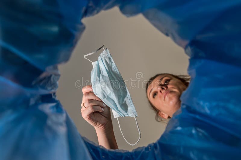 Woman Throws a Used Medical Mask into the Trash Can Stock Image - Image ...
