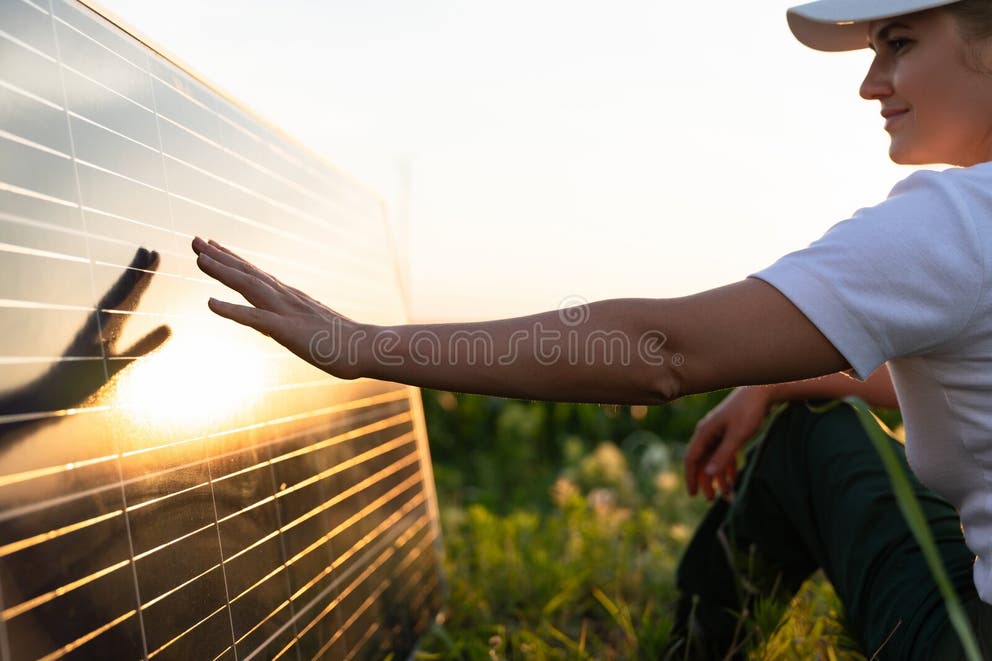 Woman Touches a Solar Panel at Sunset Stock Photo - Image of ...