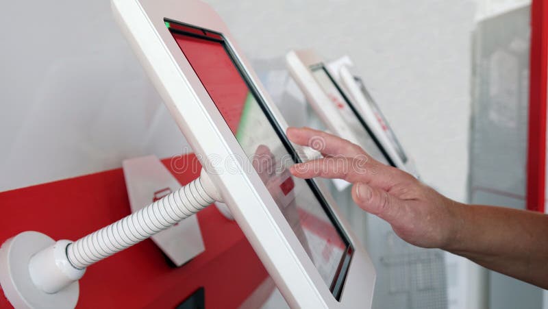 A Woman Touches the Touch Screen of a Self-service Device at the ...