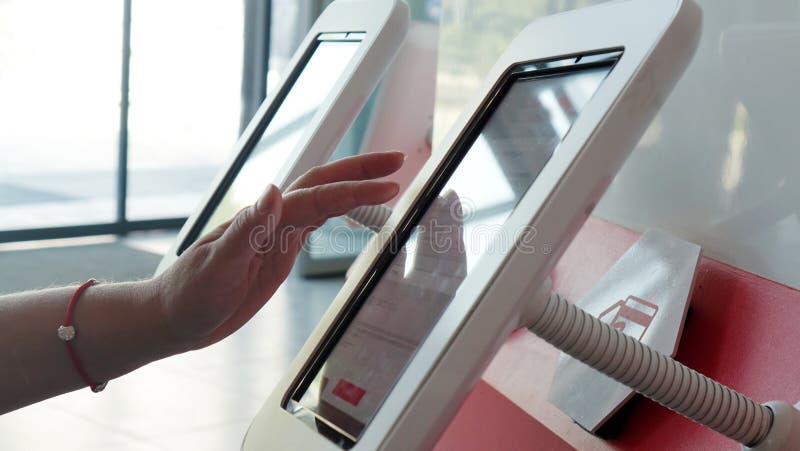 A Woman Touches the Touch Screen of a Self-service Device at the ...