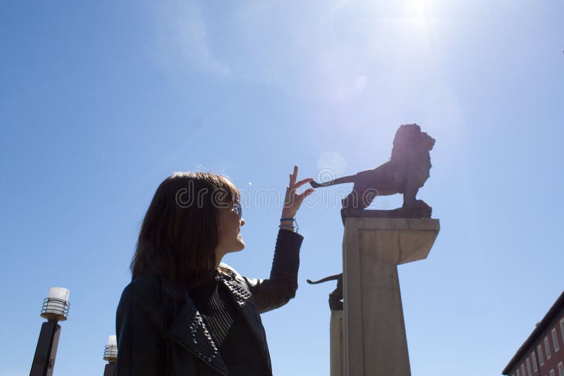 Woman Touching Lion Statue Stock Photos - Free & Royalty-Free Stock ...
