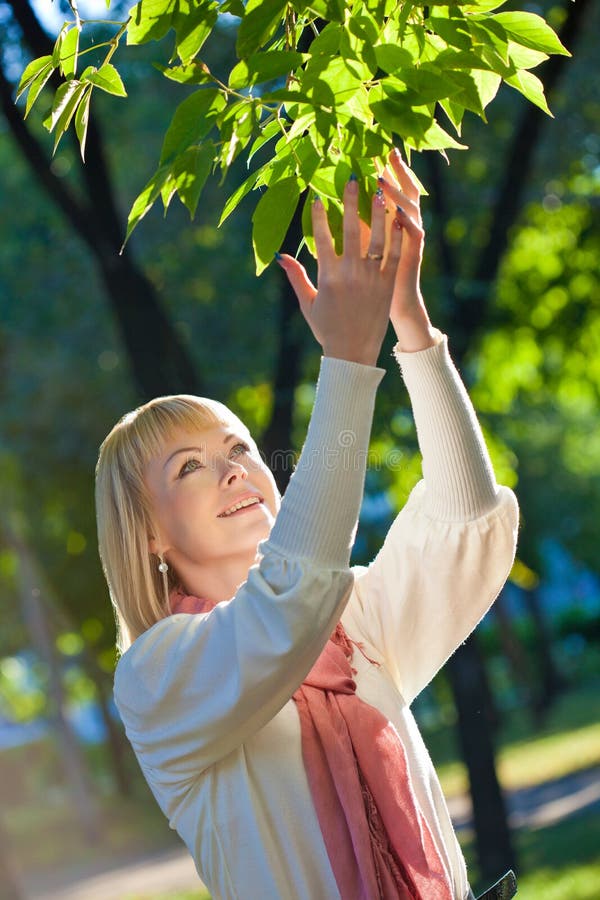 Woman touching tree leaves stock photo. Image of outside - 22713892