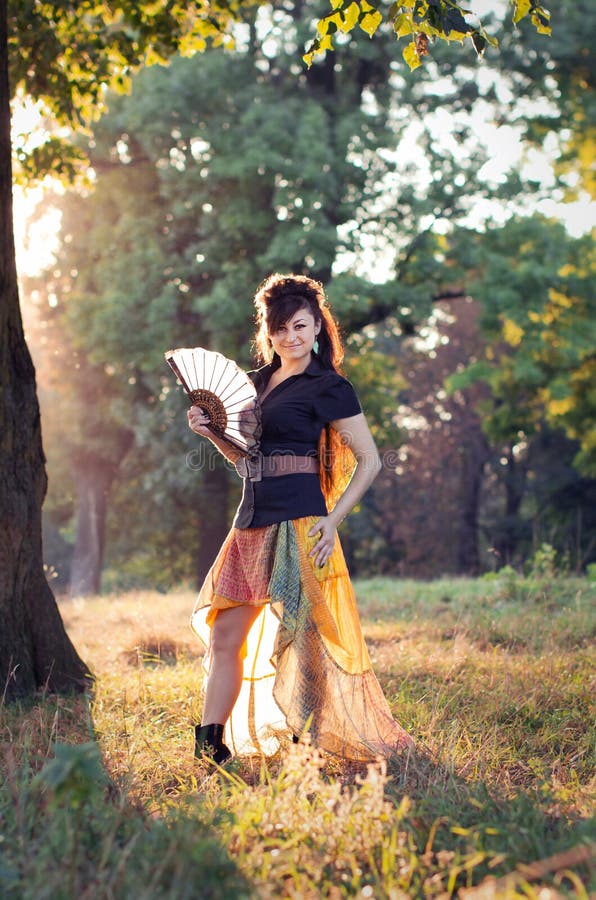 Woman with traditional fan stock photo. Image of green - 47874464