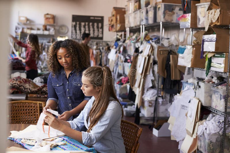 Woman Training Apprentice at Clothes Manufacturing Workshop Stock Photo ...