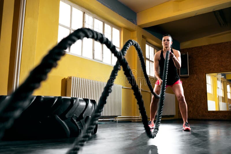 Woman Training with Battle Ropes in Gym Stock Photo - Image of ...