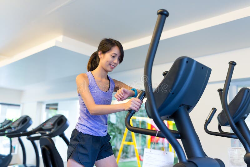 Woman Training on Elliptical Machine at Gym Stock Photo - Image of ...