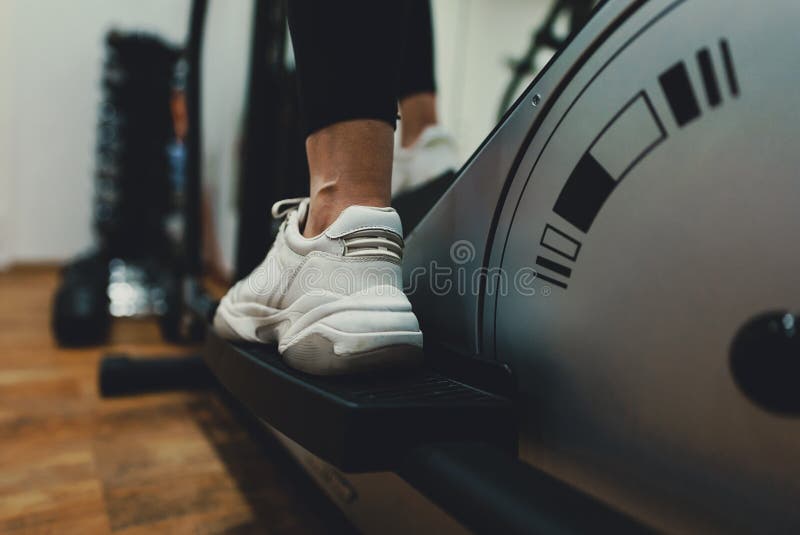 Woman Training on Elliptical Trainer Stock Image - Image of close ...