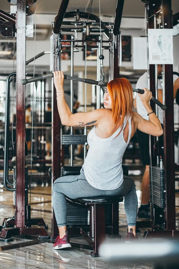 Woman Training Her Back and Shoulder with in a Gym Stock Photo - Image ...