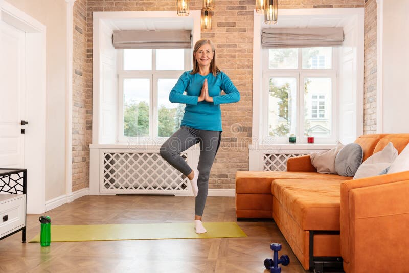 Woman in Tree Pose Standing on One Leg, Hands in Namaste. Stock Image ...