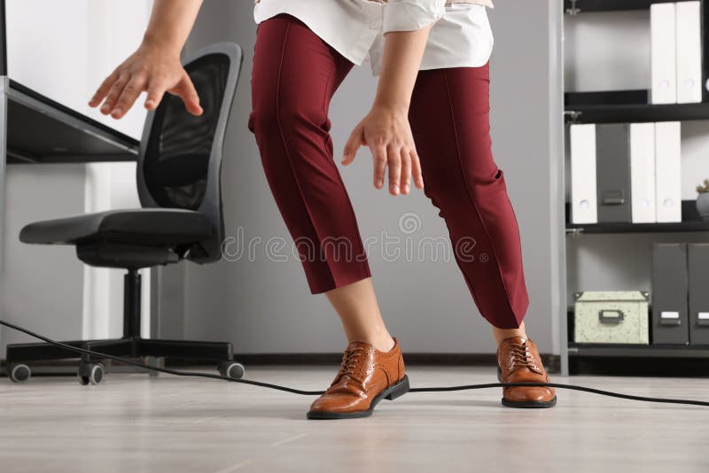 Woman Tripping Over Cable in Office, Closeup Stock Photo - Image of ...