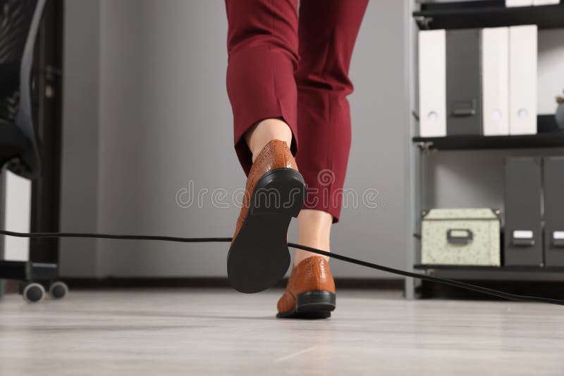 Woman Tripping Over Cable in Office, Closeup Stock Photo - Image of ...