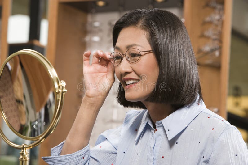 Woman Trying Out Glasses stock image. Image of attractive - 29650571