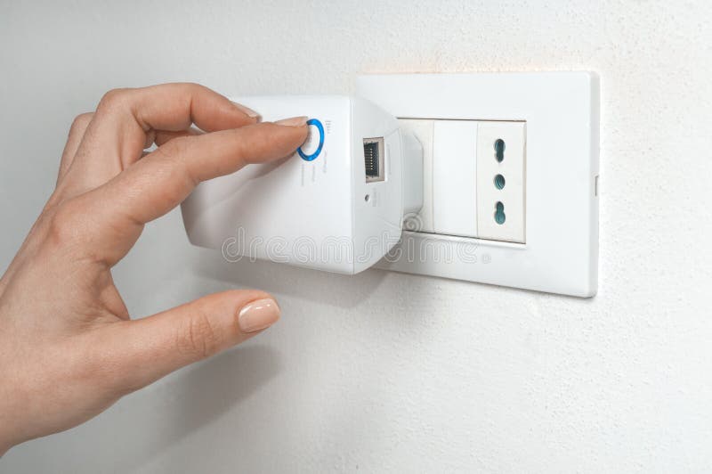Woman Turn on a Wifi Repeater Plugged on a Wall Plug Stock Image ...