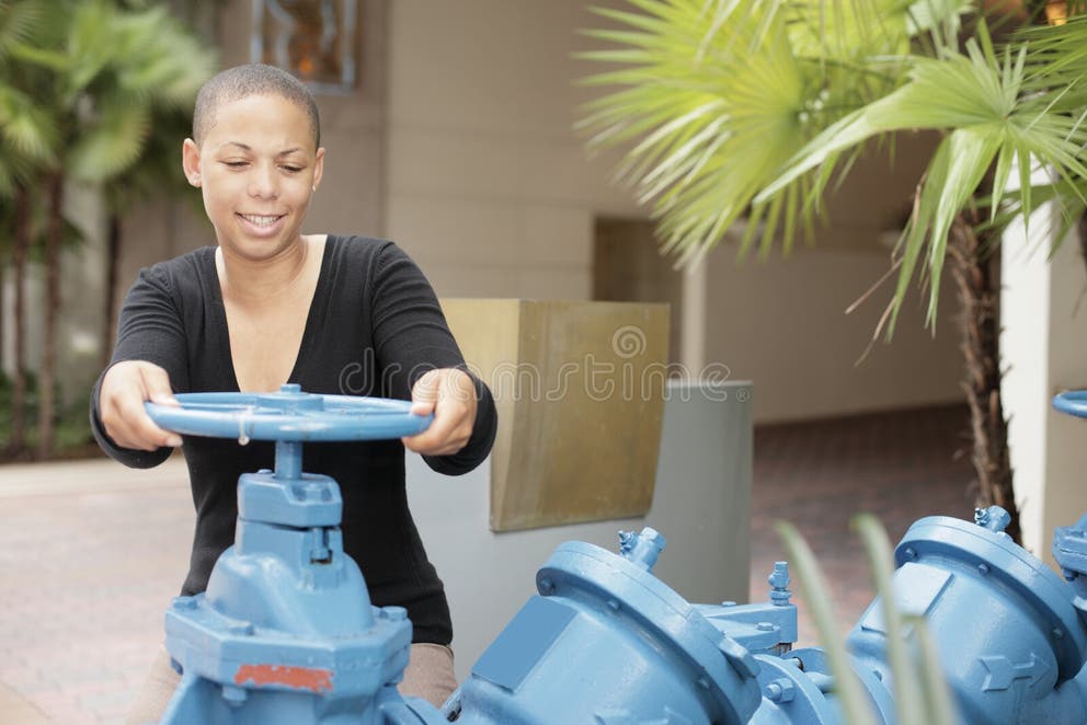 Woman turning the valve stock image. Image of diversity - 15203719