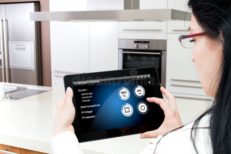 A Woman Turns on the Oven by Tablet S Smarthome Application. Stock ...