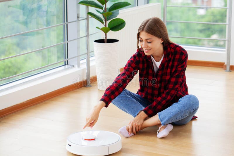 Woman Turns on Smart Robot Vacuum Cleaner. Stock Image - Image of house ...