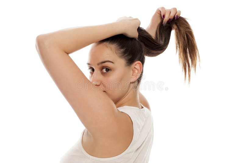 Woman tying her hair stock photo. Image of simple, young - 106611206