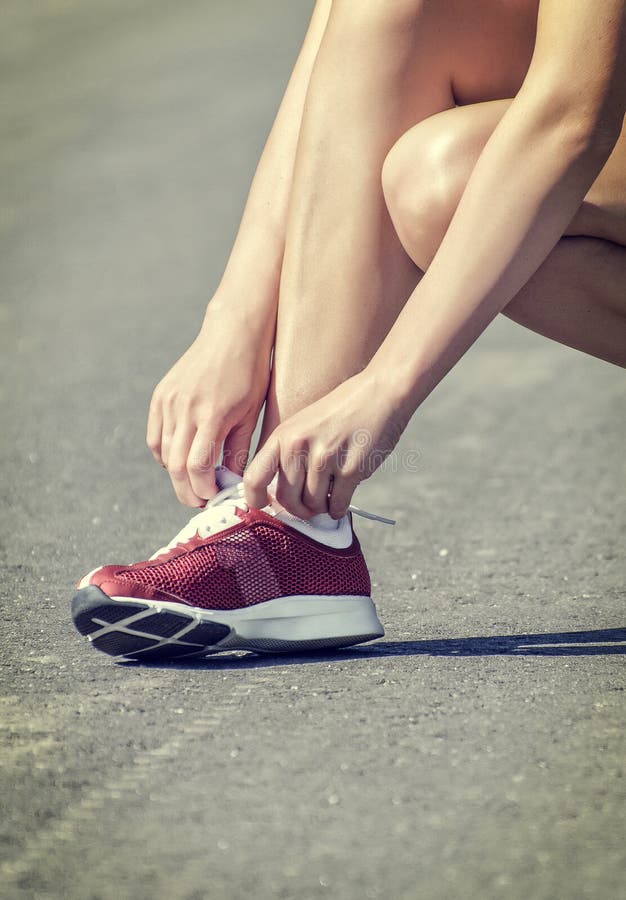 Woman tying laces stock photo. Image of shoelace, outdoors - 33268368