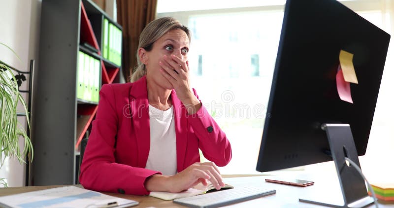 Woman is Typing on Computer Keyboard and Looks at Screen in Shock and ...