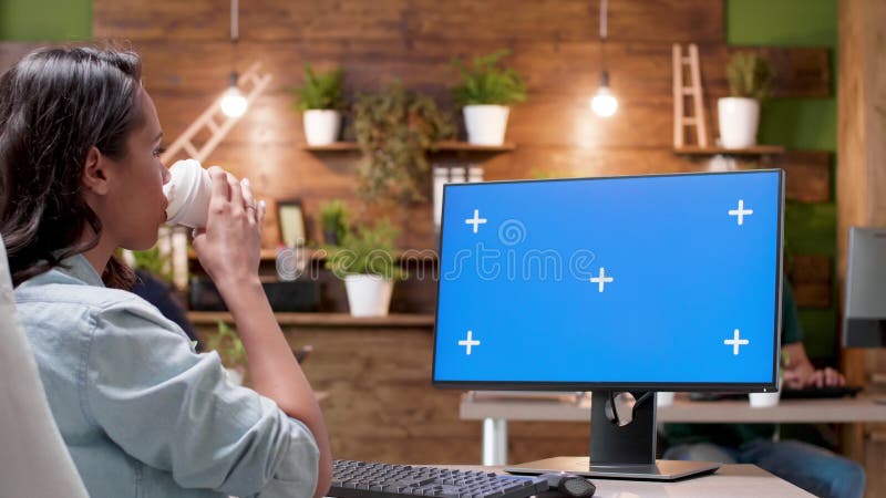 Woman Typing on Computer and Sips Coffee in Front of a Screen Mock-up ...